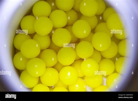 Yellow Bright Vitamins Of Ascorbic Acid In A White Jar From A Bottle