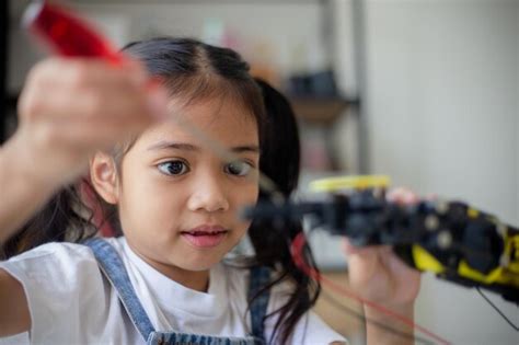 Premium Photo Stem Education Concept Asian Young Girl Learning Robot Design