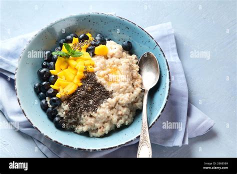 Oatmeal Porridge With Berries And Fruit On Grey Background For Healhy