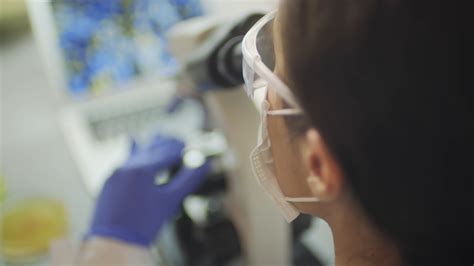 A Woman Looking Through A Microscope · Free Stock Video