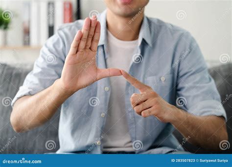 Happy Young Deaf Man Using Sign Language To Communicate With Other