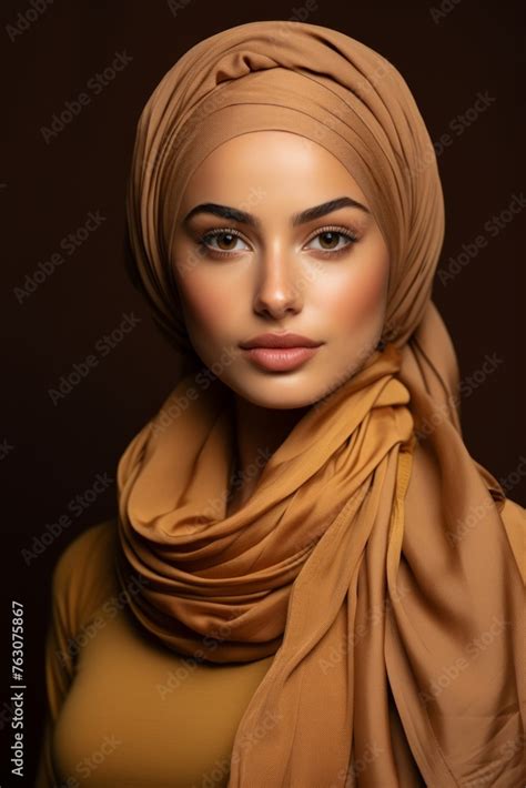 A Muslim Woman Proudly Wearing A Brown Head Scarf Also Known As A