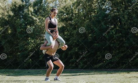 Athletic Couple Exercising Outdoors In The Park On A Sunny Day Stock