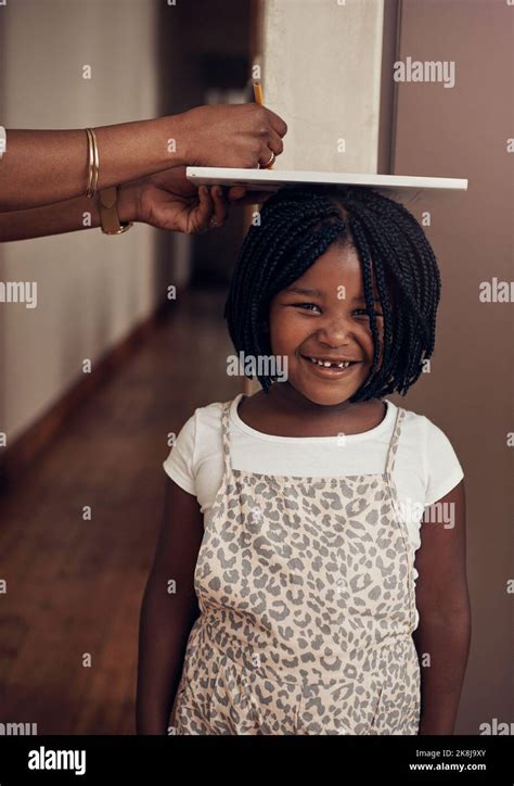 Shes Getting Bigger By The Day A Mother Measuring The Height Of Her