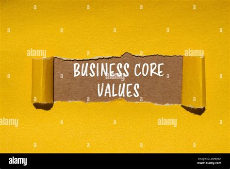Business Core Values Message Written On Ripped Torn Yellow Paper With