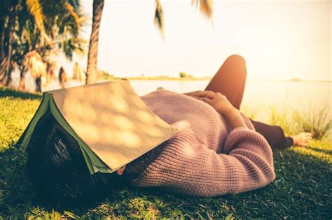 Premium Photo Young Woman Lying On Grass