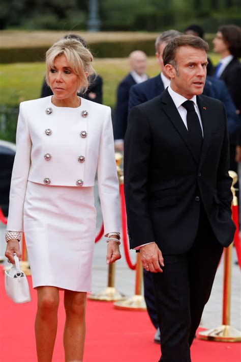 French First Lady Brigitte Macron Suits Up In Louis Vuitton Cropped Jacket And Skirt At Olympics