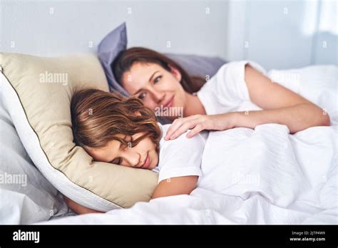 Spending Her Day Off With Her Daughter A Mother And Daughter Sleeping Together In Bed At Home