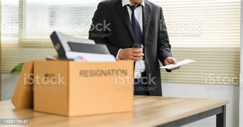 Resignation Letter And Cardboard Box On The Table Termination And