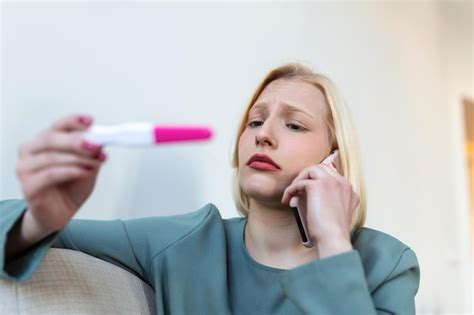 Premium Photo Shocked Woman Looking At Control Line On Pregnancy Test