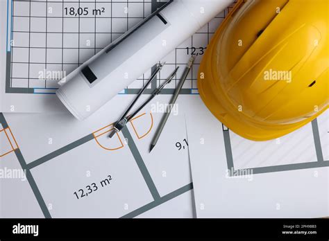 Rolled Construction Drawing Safety Hat Pair Of Compasses And Pencil On House Plan Flat Lay