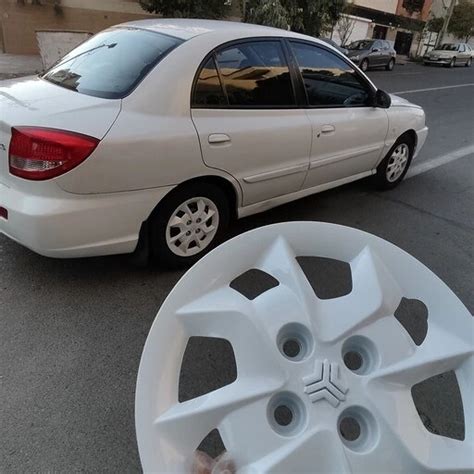 خرید و قیمت قالپاق ریو سفید رنگ سایز رینگ و لاستیک فابریک چرخ ماشین 14 اینچ مدل پیچی Rio سایپا ترب