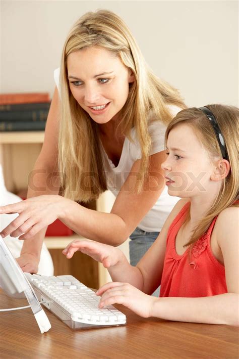 Mother And Daughter At Home Using Computer Stock Image Colourbox