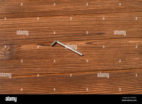 This Image Shows A Small Metal Allen Key L Keys Lying On A Wooden