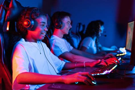 Free Photo Group Of Multiracial Teens In Headsets Playing Video Games