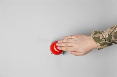 Serviceman Pressing Red Button Of Nuclear Weapon At Black Table