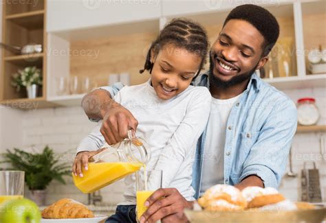 Time For Vitamin C Cute Little African Girl Pouring Fresh Orange Juice