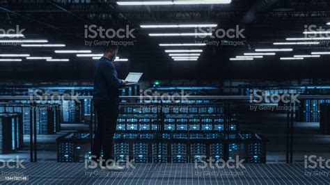 Data Center Engineer Using Laptop Computer Server Farm Cloud Computing Specialist Facility With