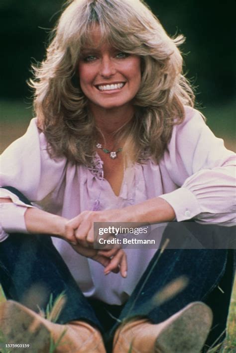 American Actress Farrah Fawcett Majors Smiling And Sitting On Grass
