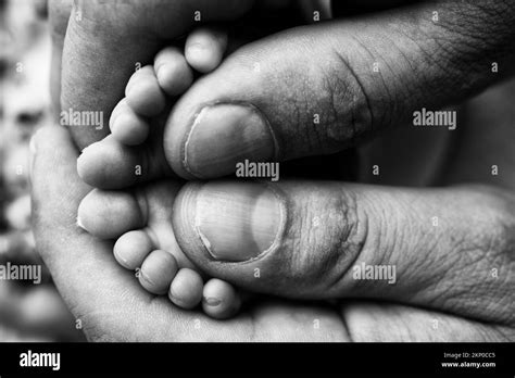 Mother Is Doing Massage On Her Baby Foot Closeup Baby Feet In Mother