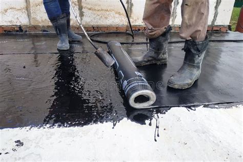 Worker Covered Surface Bitumen Primer For Improving Adhesion During Surfacing Rolled