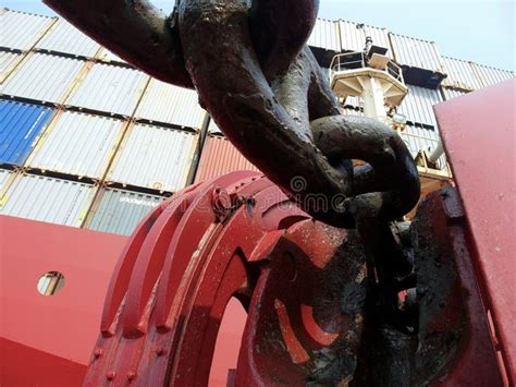 Anchor Chain And Red Forward Starboard Side Mooring Winch And Anchor Windlass Of Cargo Container