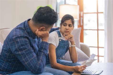 Young Couple Indian Calculate The Bill Together Have Serious Looks
