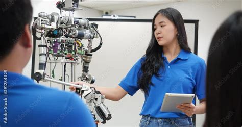 Asian Woman Engineer Present Robot Innovation With Architects Design Team In Laboratory Team