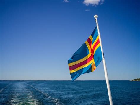 Flag Flags On Sea Against Clear Blue Sky Premium Photo