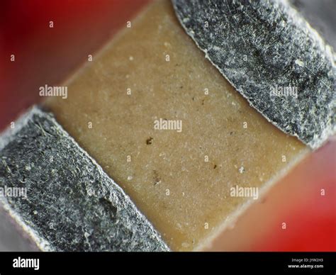 Reflected Light Micrograph Of A Surface Mount Capacitor Pictured Area Is About 1 7mm Wide Stock