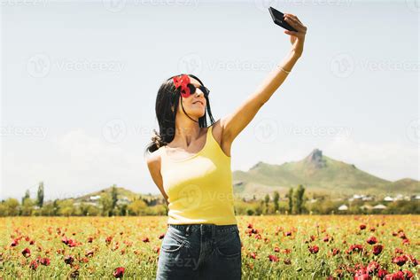 Beautiful Caucasian Woman Pose Selfie With Smartphone In Nature For Social Media Outdoors On