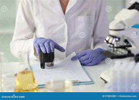 Researcher Putting Stamp On Documents With Research Results Stock Image