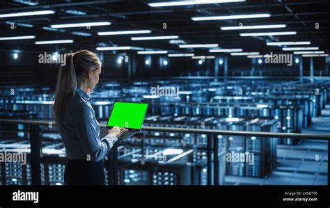 Female It Specialist Using Chroma Key Laptop In Data Center Big Server