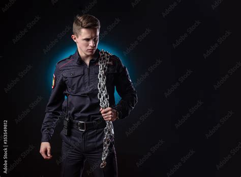 A Handsome Guy In A Police Uniform With A Big Chain On His Shoulder