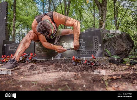 Stone Engraver Working In A Cemetery Carving Letters On Headstone With