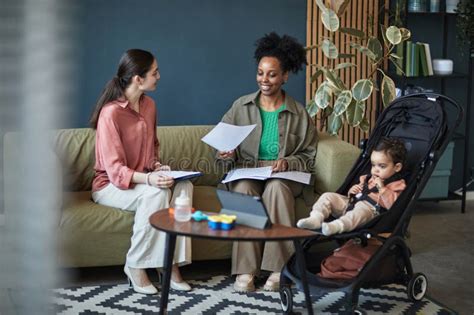 Discussing Work Documents In Casual Office Setting Stock Image Image Of Collaborate