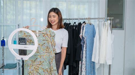 Beautiful Woman Influencer Showing Clothes In Front Of Smartphone To