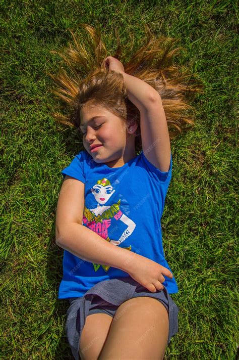 Premium Photo High Angle View Of Teenage Girl Lying On Grassy Field