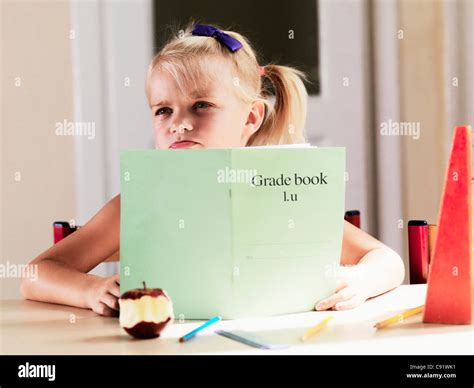 Bored Girl Doing Homework At Desk Stock Photo Alamy