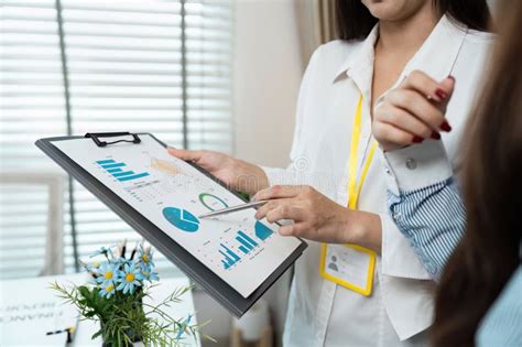 Business Meeting With Professional Presentation And Data Analysis On Clipboard In Modern Office