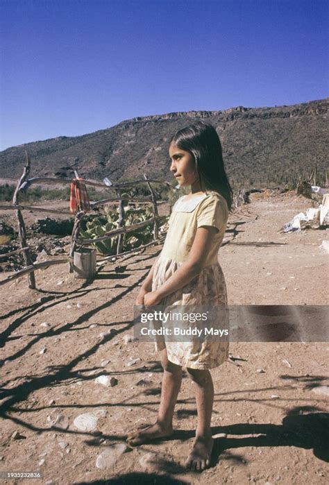 A Barefoot Young Mexican Girl Looks Out Across Her Fathers Tiny