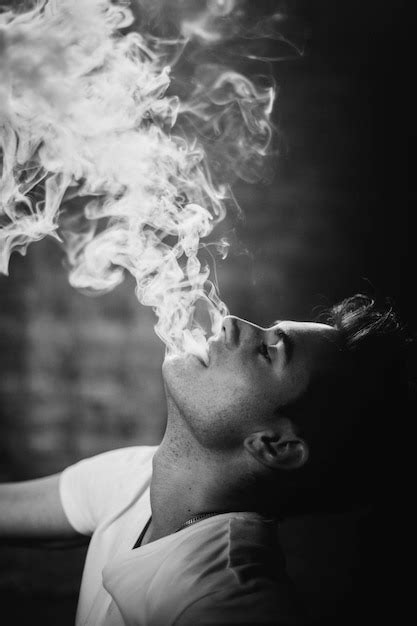 Premium Photo Close Up Of Young Man Smoking Cigarette