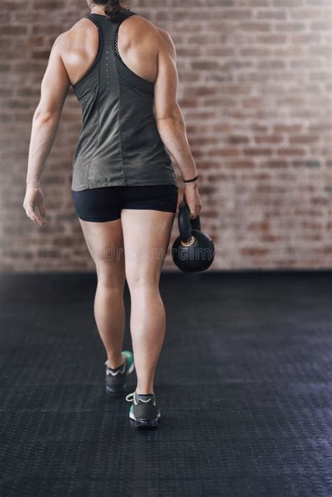Shes Always Ready To Lift Rearview Shot Of A Young Woman Working Out