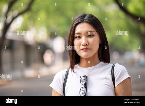Street Portrait Of Young Beautiful Chinese Teenage Girl In The Streets