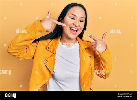 Beautiful Hispanic Woman With Nose Piercing Wearing Yellow Leather