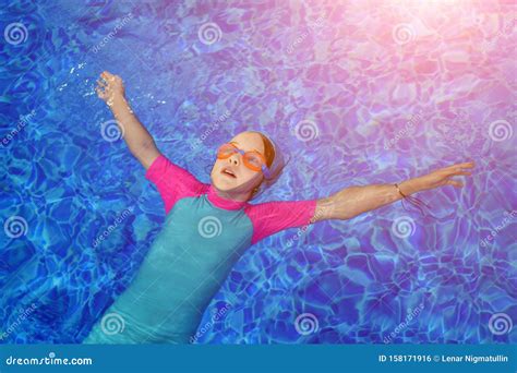 Portrait Of Calm Girl Relaxing In Clear Blue Water Of Outdoors Sunny