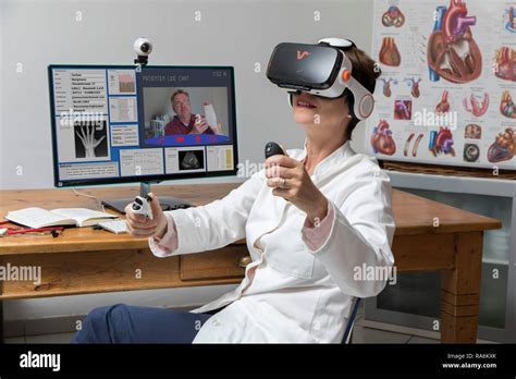 Symbol Photo For Telemedicine Doctor In A Practice With VR Glasses