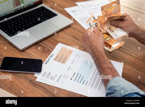 Mature Businessman Counts Euros Bills Processing Utility Bills At