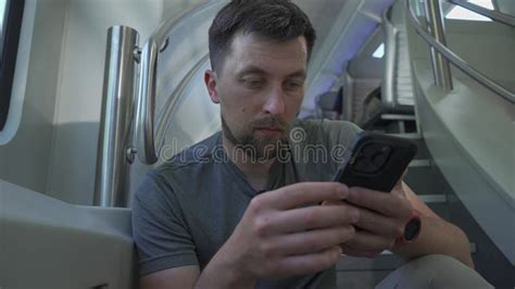 Male Takes Twin Train Sitting On A Stairway And Browsing Internet Man