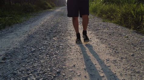 Unrecognizable Man Walking On The Rough Gravel Road Stock Footage